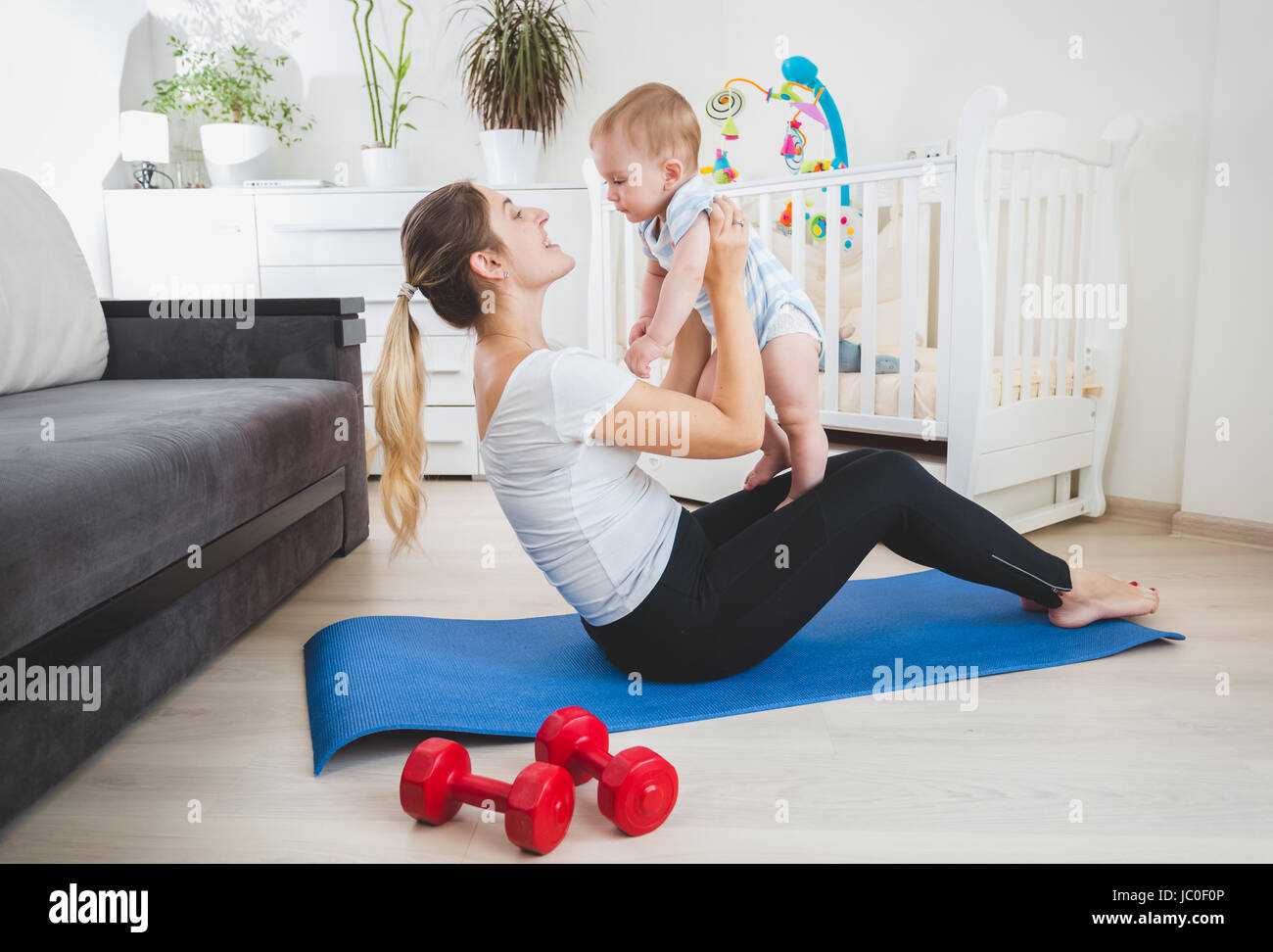 Beautiful slim mother playing baby hi-res stock photography and images ...