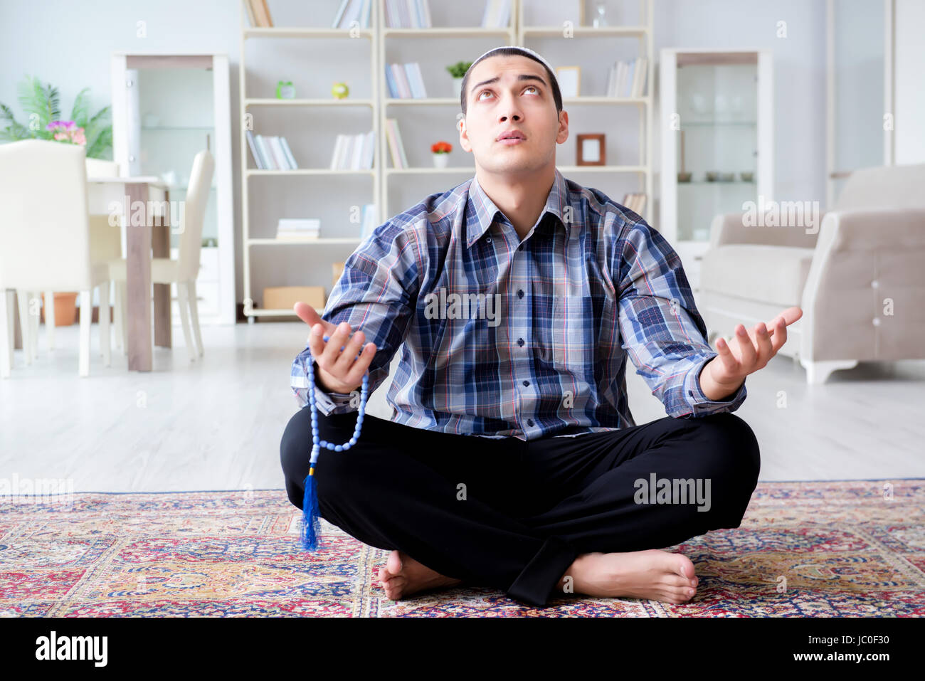Muslim man praying at home Stock Photo - Alamy