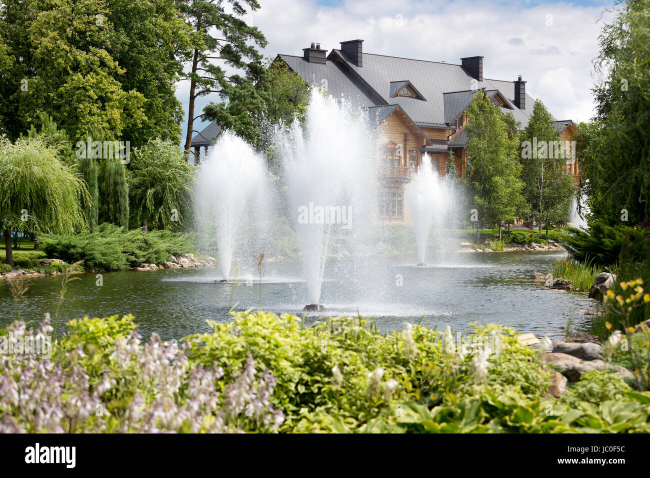 Three beautiful fountains on lake at botanical garden Stock Photo - Alamy