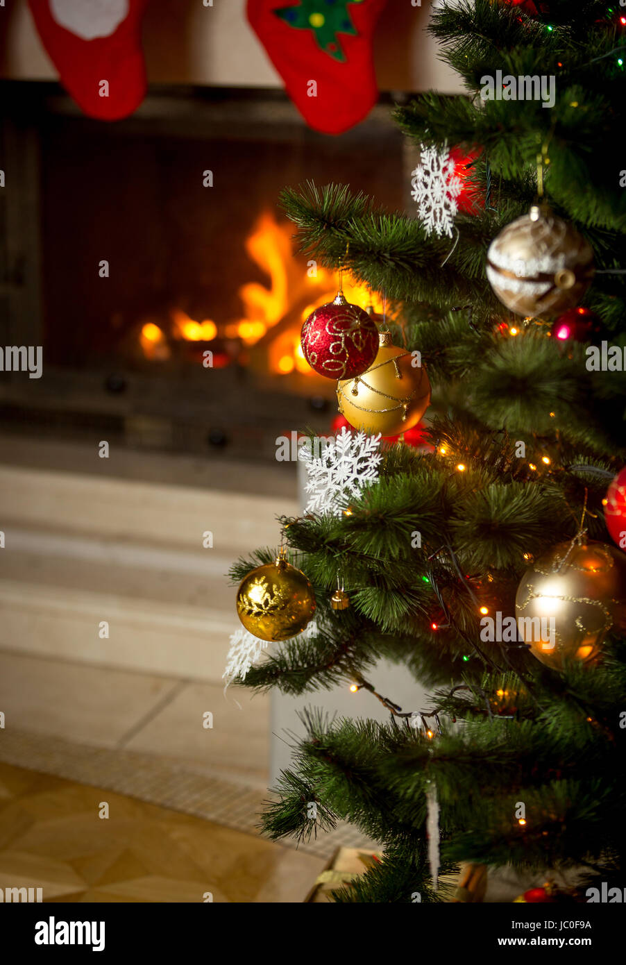 Beautiful background of decorated Christmas tree in front of burning ...