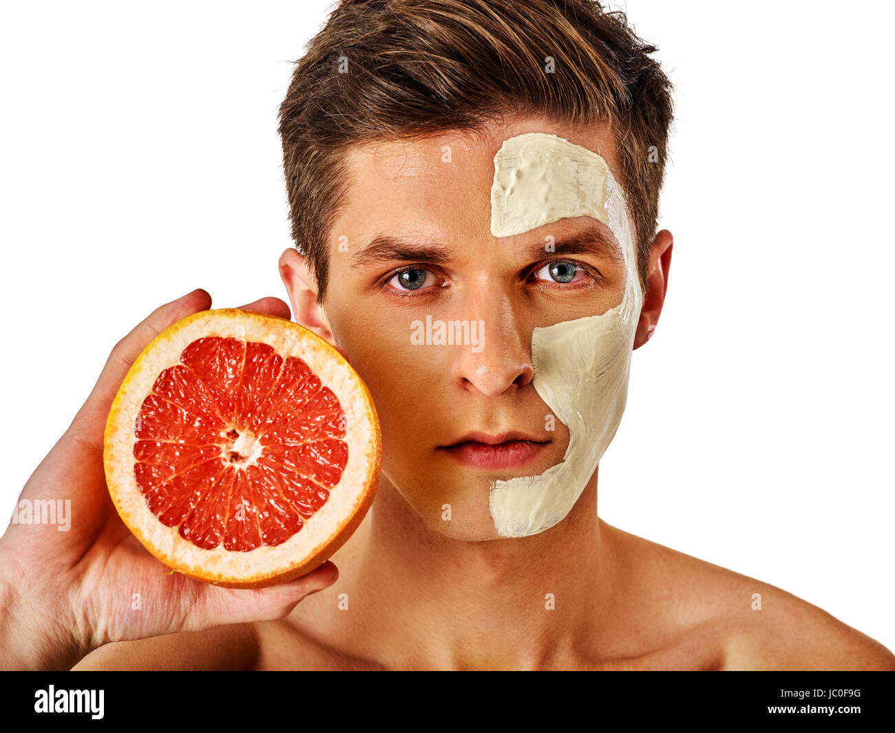 Facial mask from fresh fruits and clay for man concept. Face with treatment mud applied . Male ...
