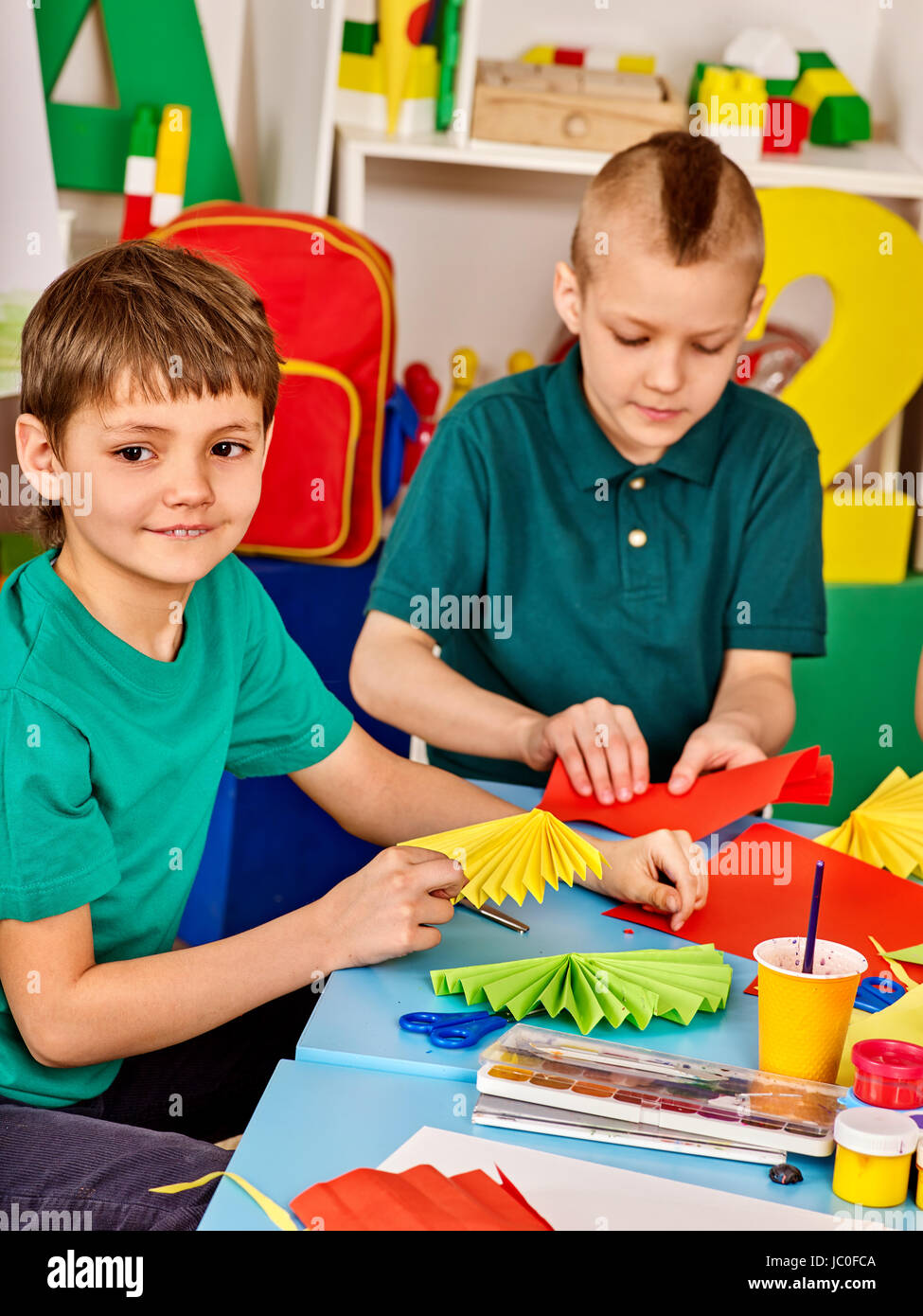 Children cutting paper in class. Kids development and social lerning ...