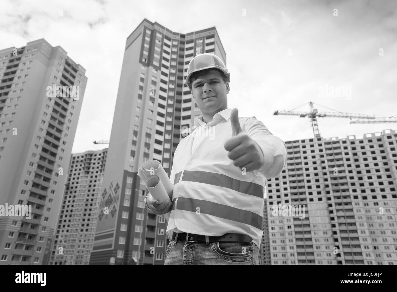 Black and white portrait of smiling successful construction engineer ...