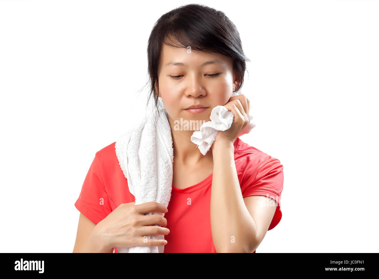 Fitness woman wiping sweat off on white background Stock Photo - Alamy