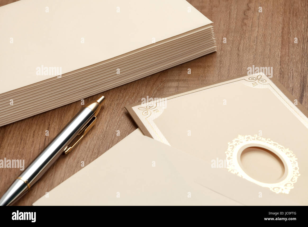 Invitation card and stack of letter on wood table Stock Photo - Alamy