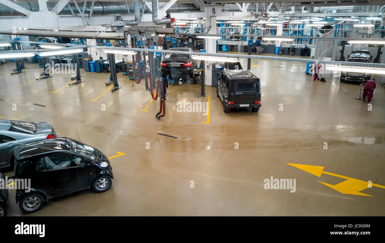 Interior of car repairing service with cars lifted above the floor ...