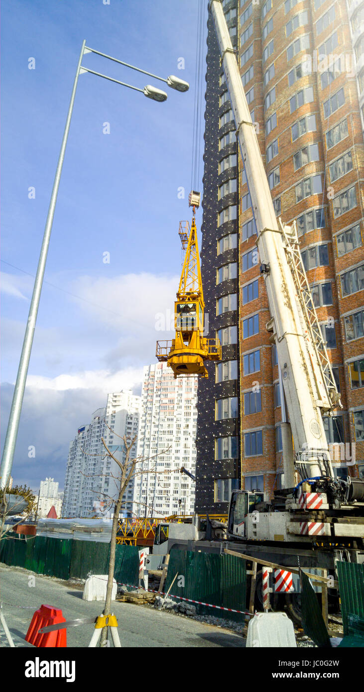 Process of assembling building crane at building site Stock Photo - Alamy