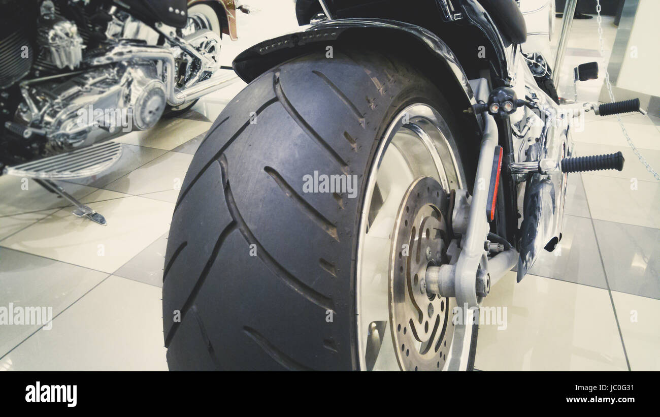 Closeup toned image of motorcycle rear wheel in showroom Stock Photo ...