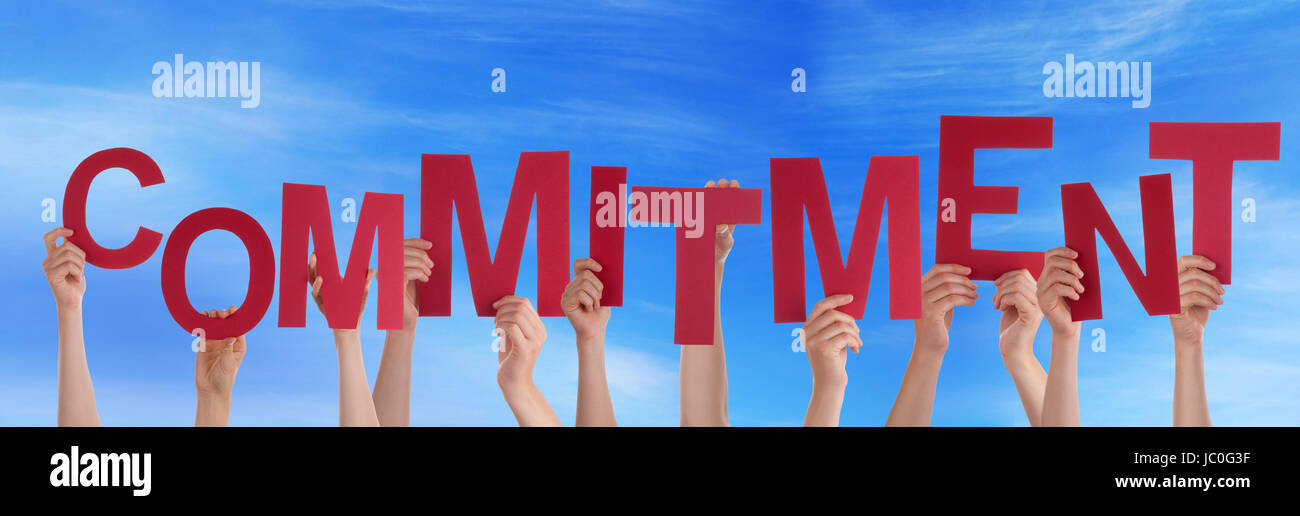 Many Hands Holding the Word Commitment in the Sky Stock Photo - Alamy