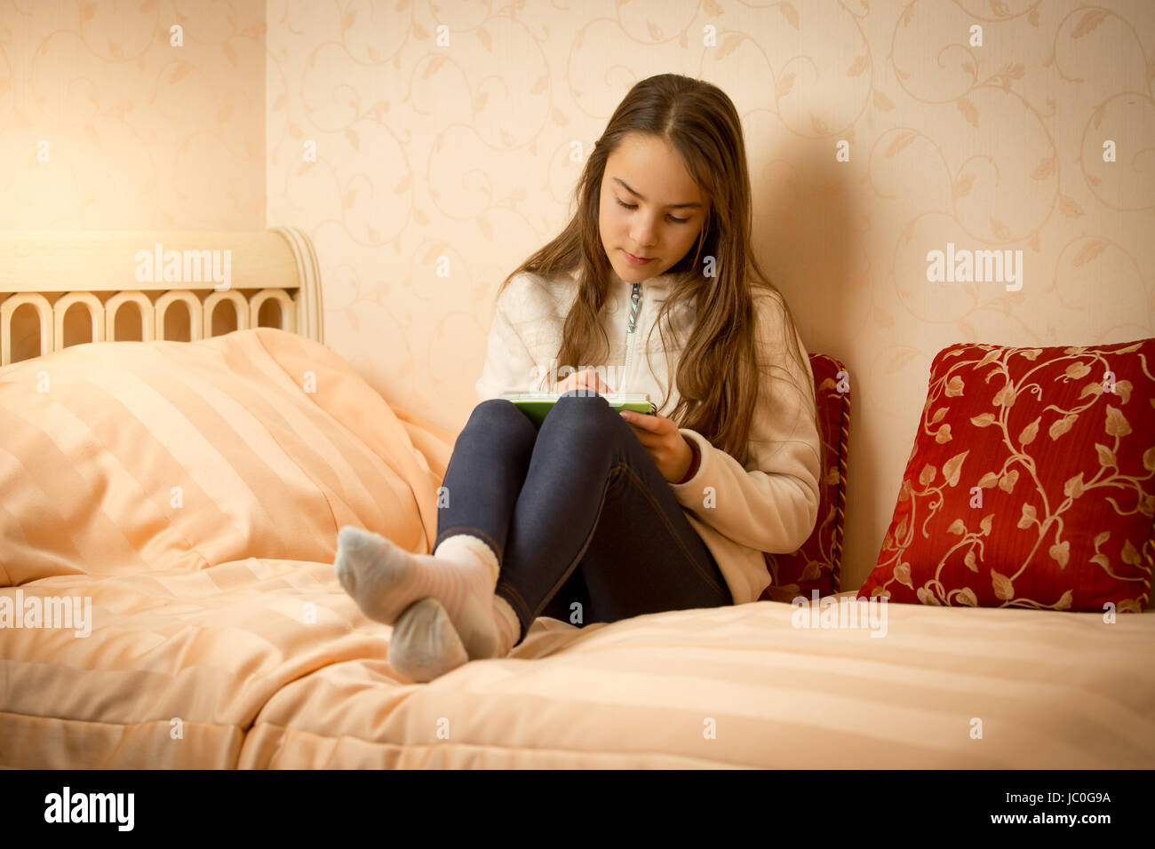 Brunette girl lying on bed with her private diary Stock Photo - Alamy