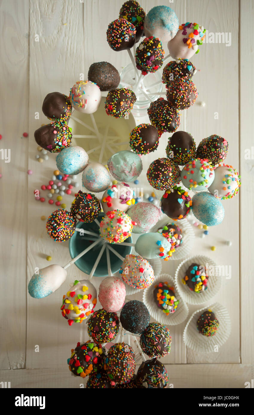 View from top on beautiful colorful cake pops on wooden table at ...