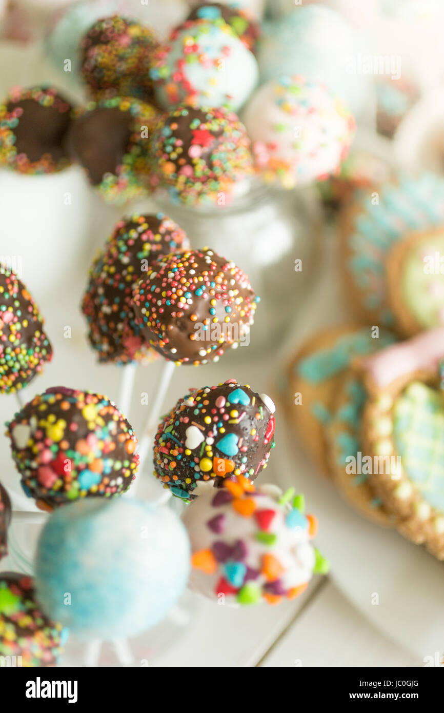 Closeup photo of beautiful colorful cake pops on white wooden ...