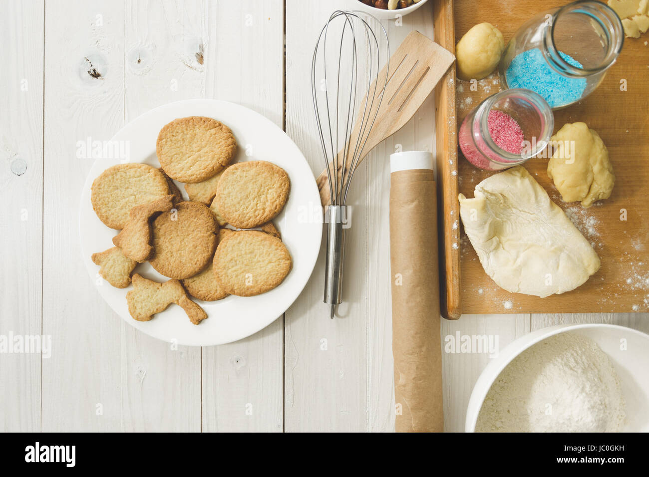 View from above on cooked cookies on dish and kitchen utensils on table ...