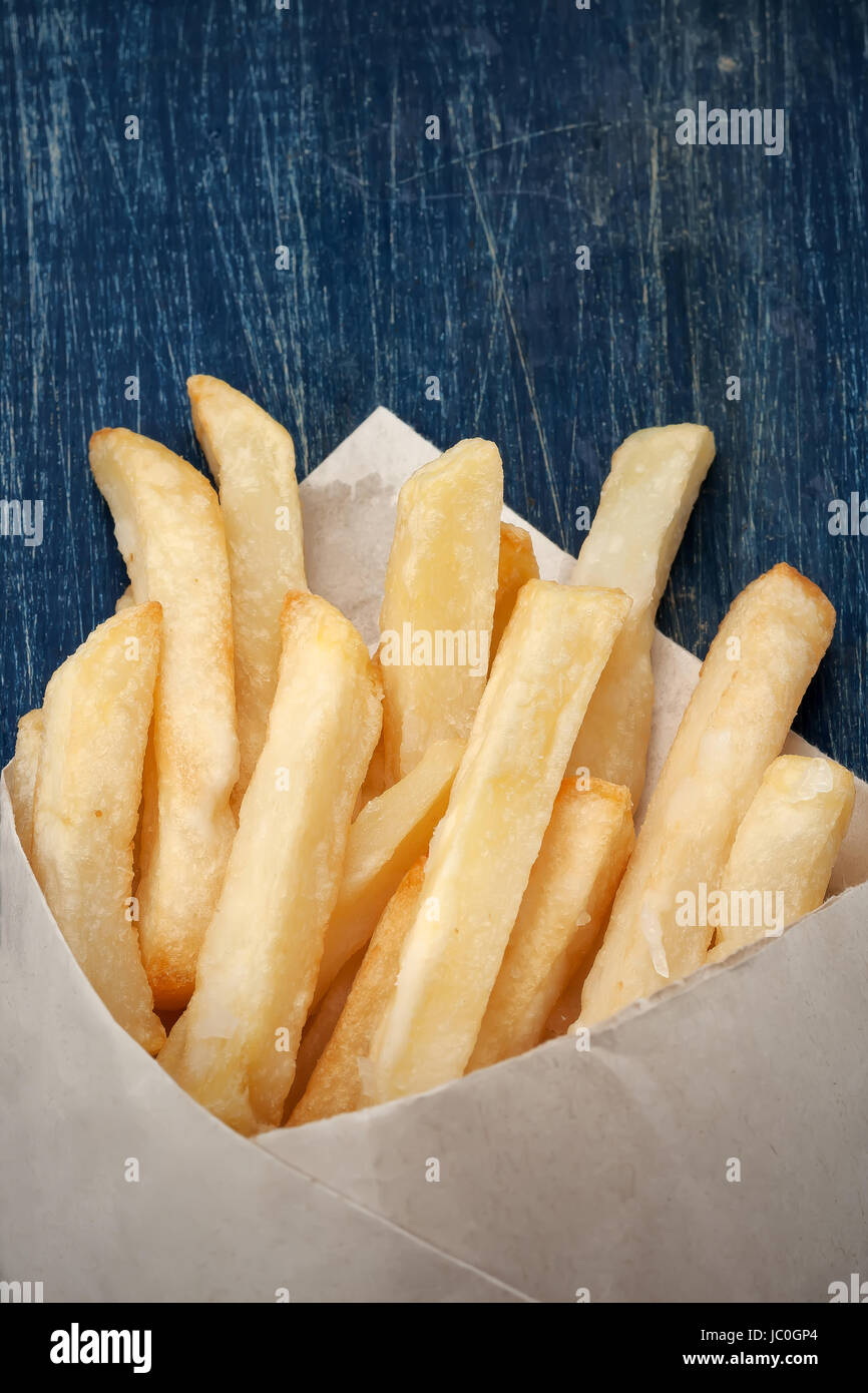 French fries in wrapping paper on retro wood Stock Photo - Alamy