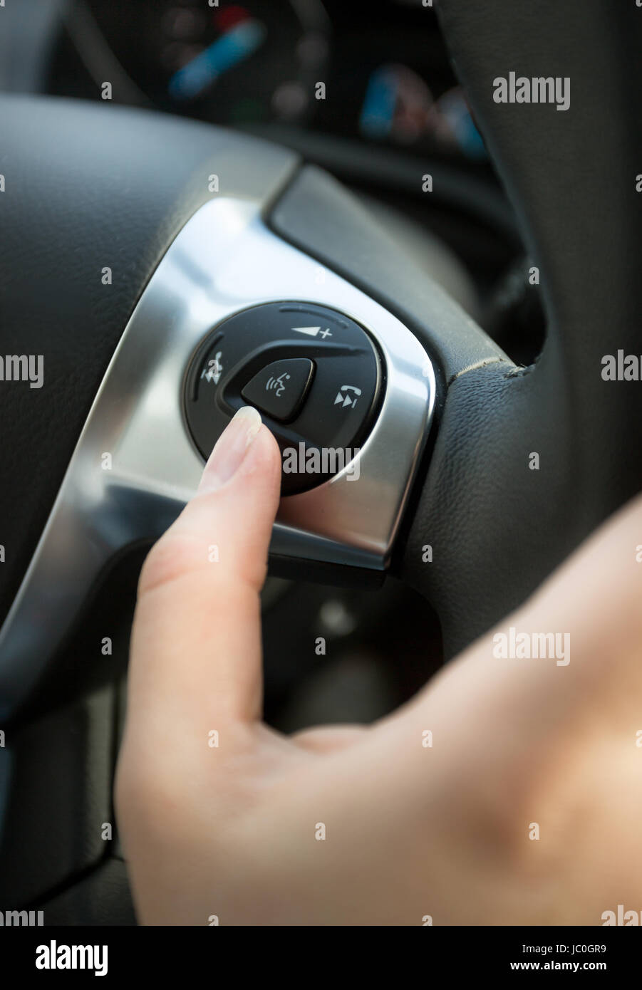 Closeup photo of driver pressing phone button on car steering wheel ...