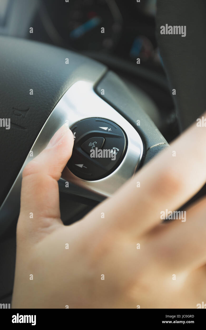 Closeup photo of driver using control panel on steering wheel Stock ...