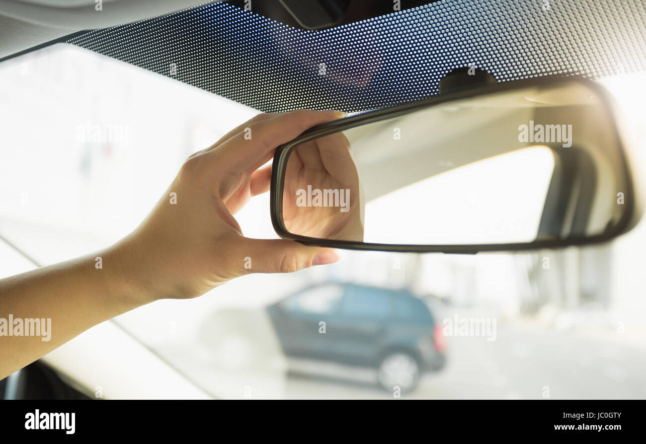Closeup photo of driver adjusting rear view mirror Stock Photo - Alamy