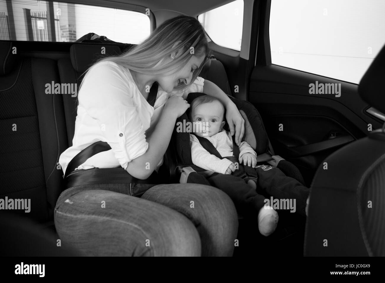 Young boy sitting on chair Black and White Stock Photos & Images - Alamy