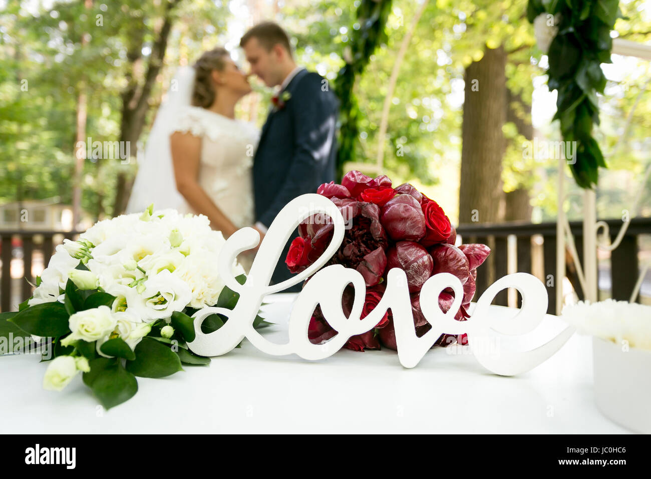 Closeup photo of decorative sign "Love" on table at wedding ceremony ...