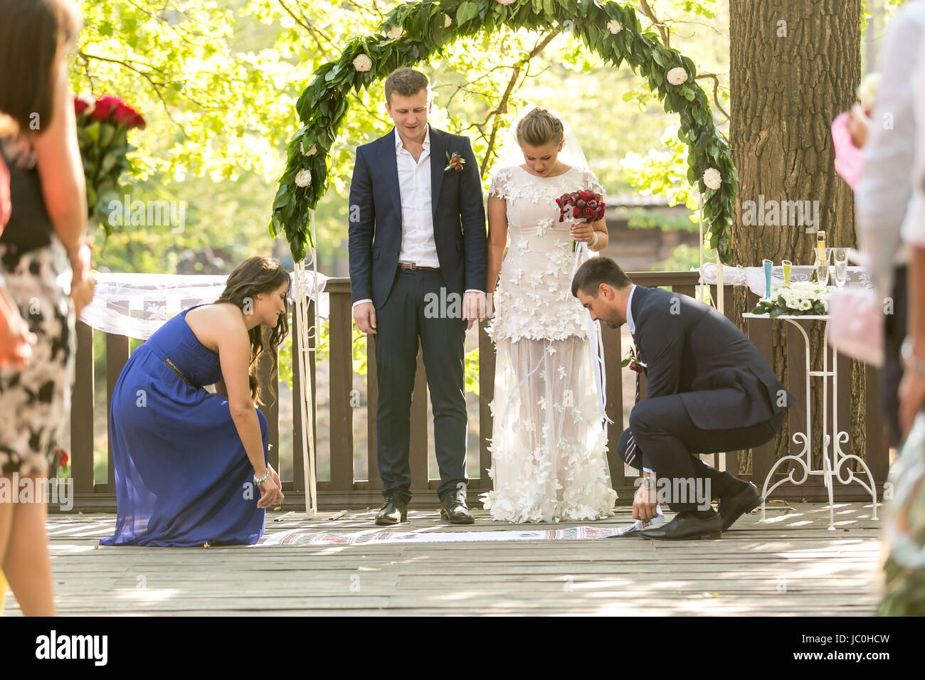 Beautiful newly married couple having traditional unity rite during ...