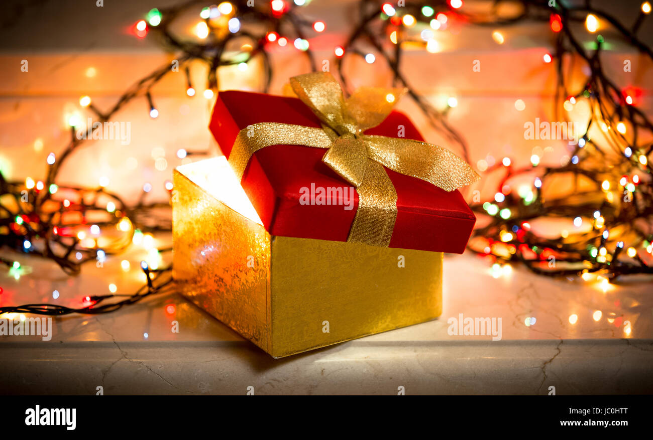 Closeup photo of open gift box with light coming out of it Stock Photo ...