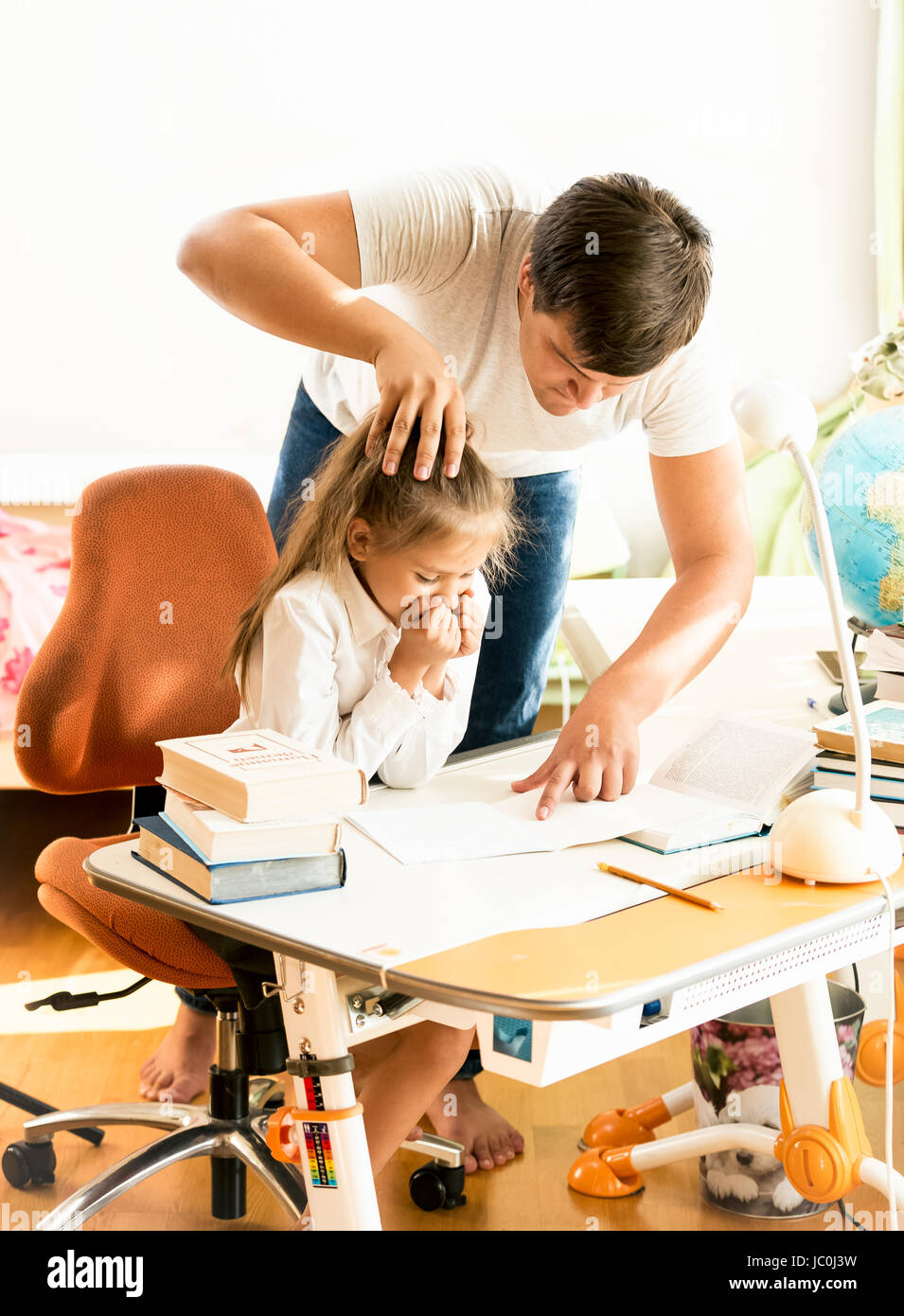 Angry father pointing at mistake at daughters notebook Stock Photo - Alamy