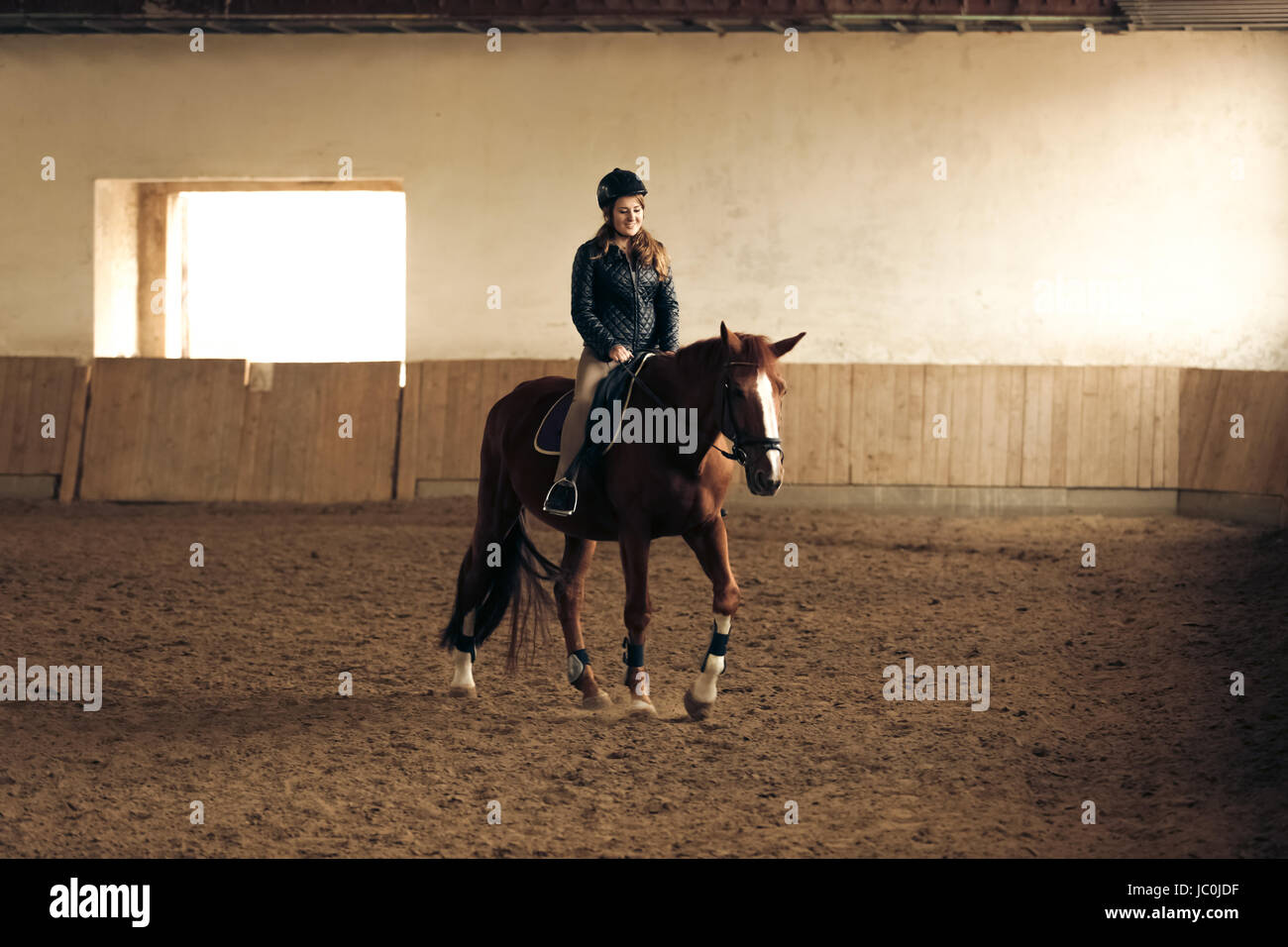 Young woman and her horse riding hall hi-res stock photography and ...