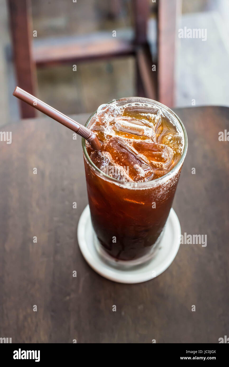 Iced black coffee on the wooden table in coffee cafe Stock Photo - Alamy