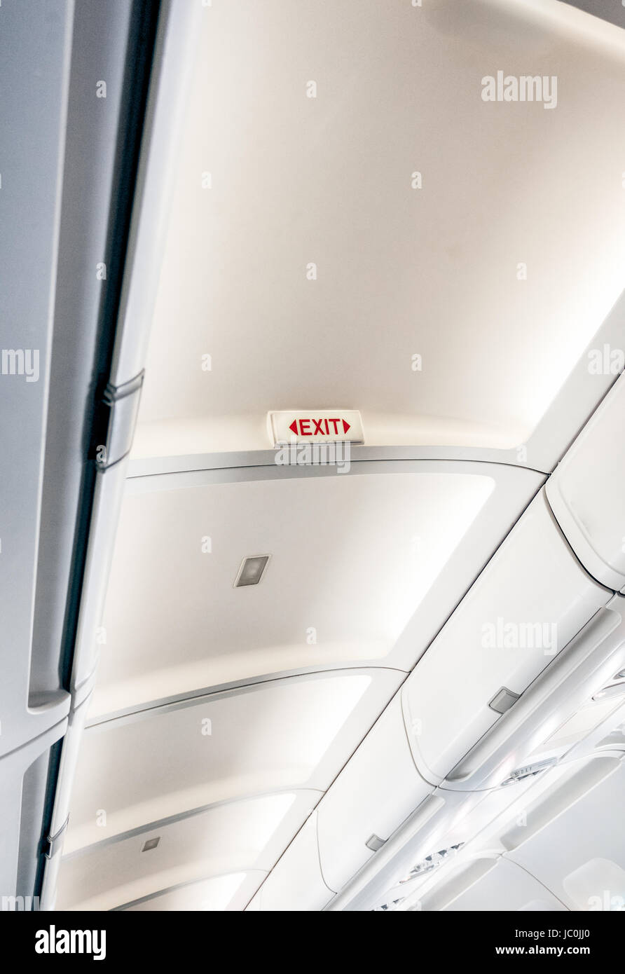 Photo of exit sign on ceiling on aircraft with lights Stock Photo - Alamy