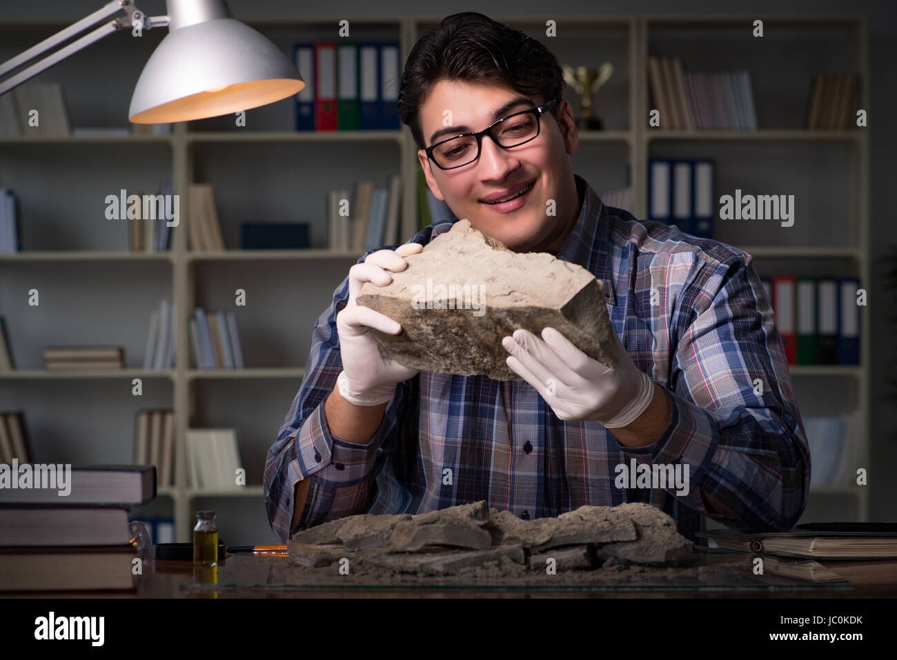 Archeologist working late night in office Stock Photo - Alamy