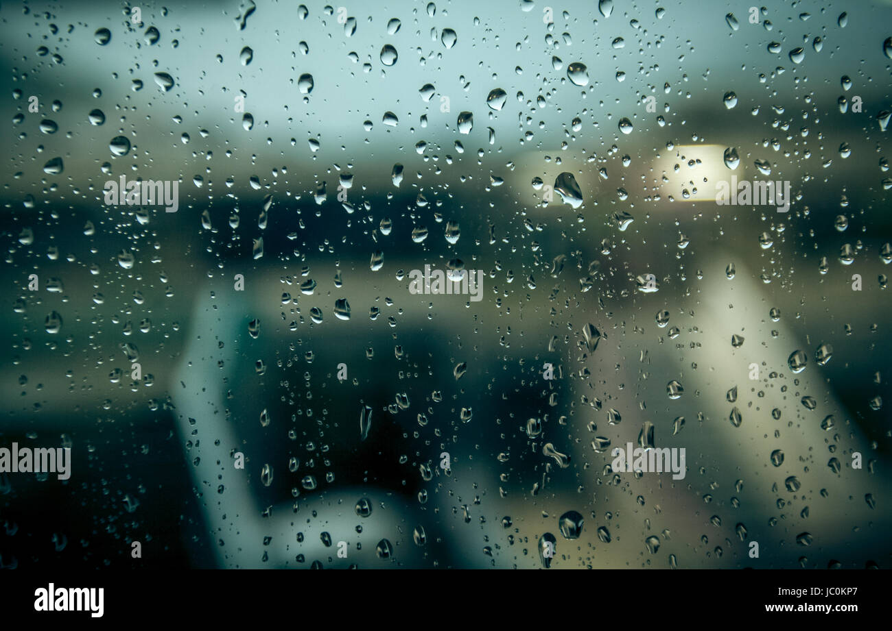 Photo of blurred building through window with raindrops Stock Photo - Alamy