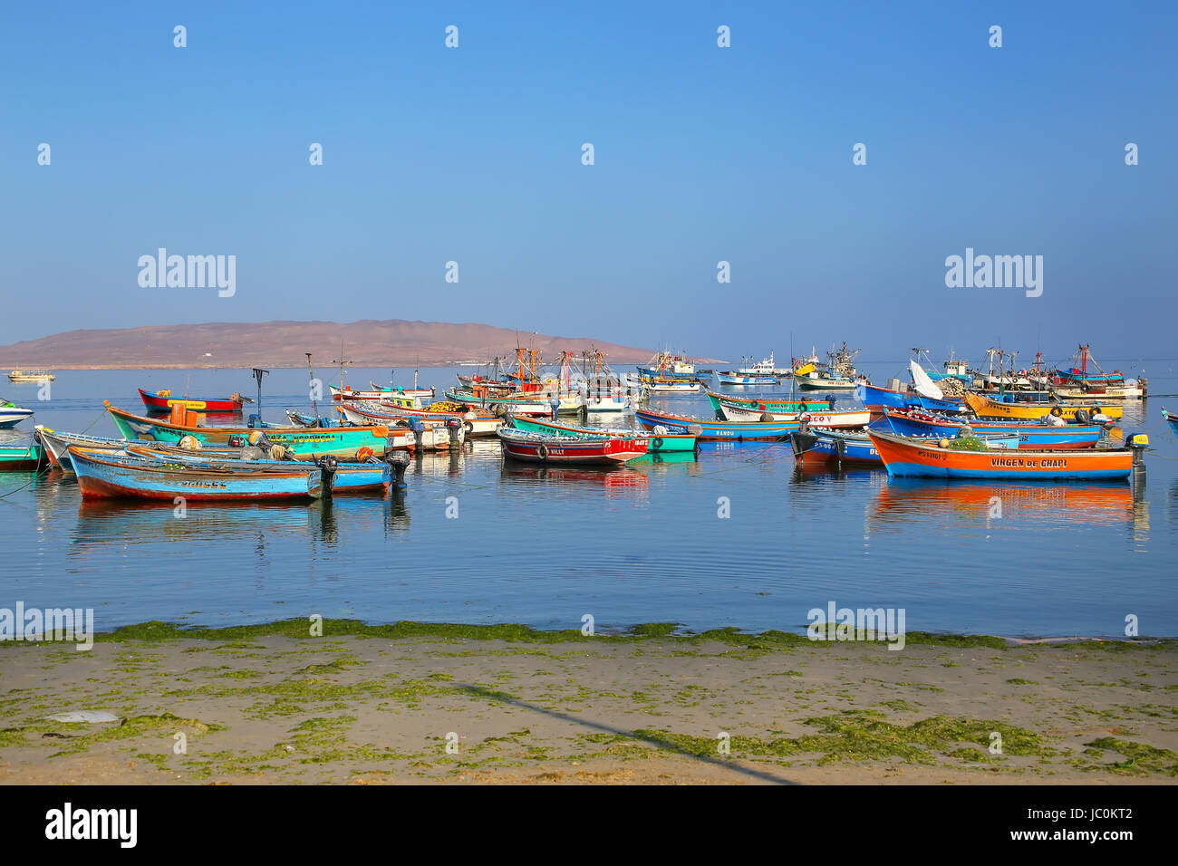 Colorful fishing boats anchored in Paracas Bay, Peru. Paracas is a ...