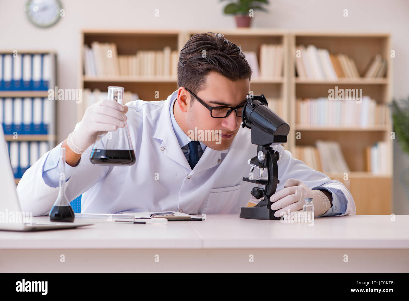 Young lab assistan working in the laboratory Stock Photo - Alamy