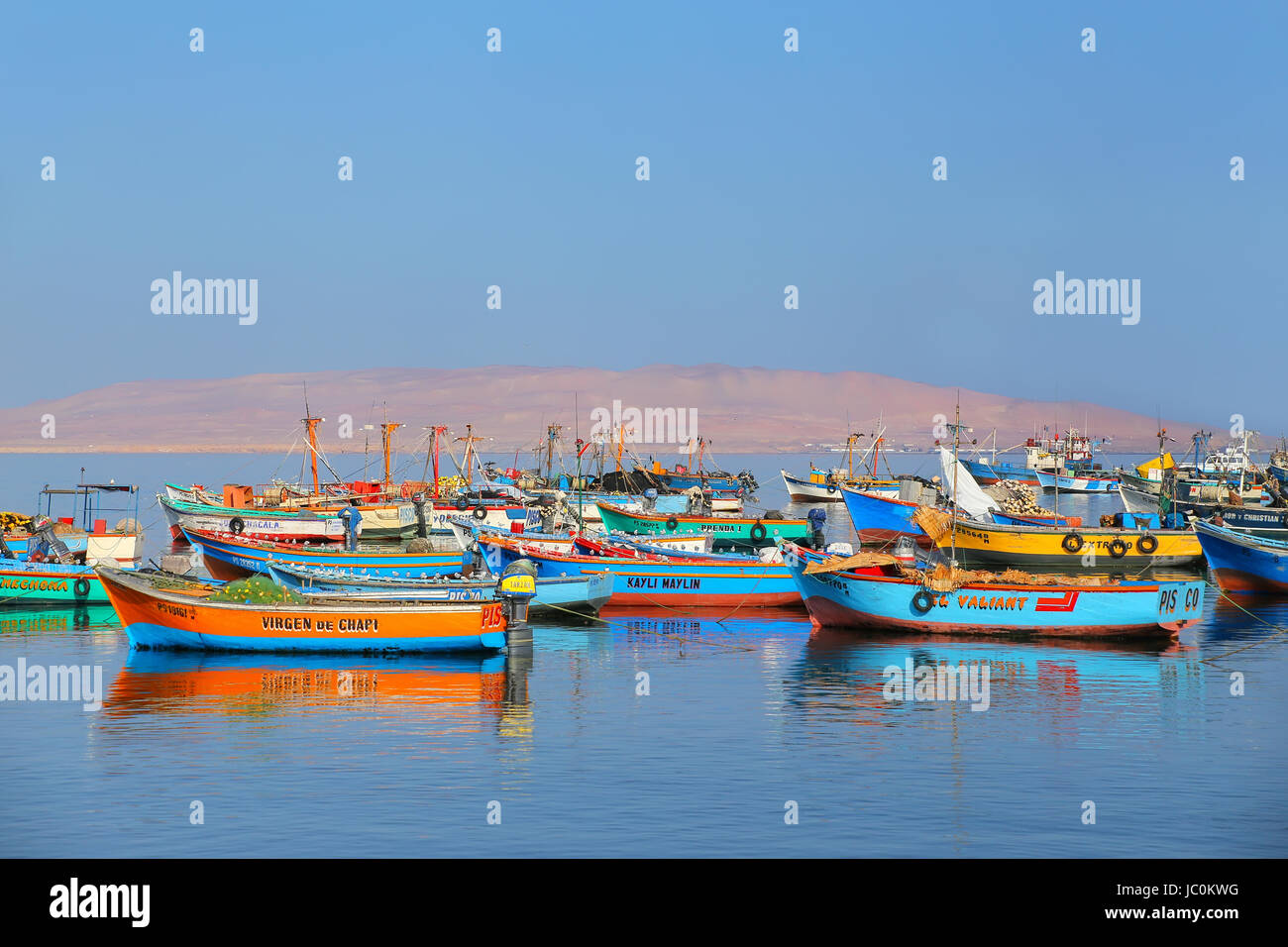 Colorful fishing boats anchored in Paracas Bay, Peru. Paracas is a ...