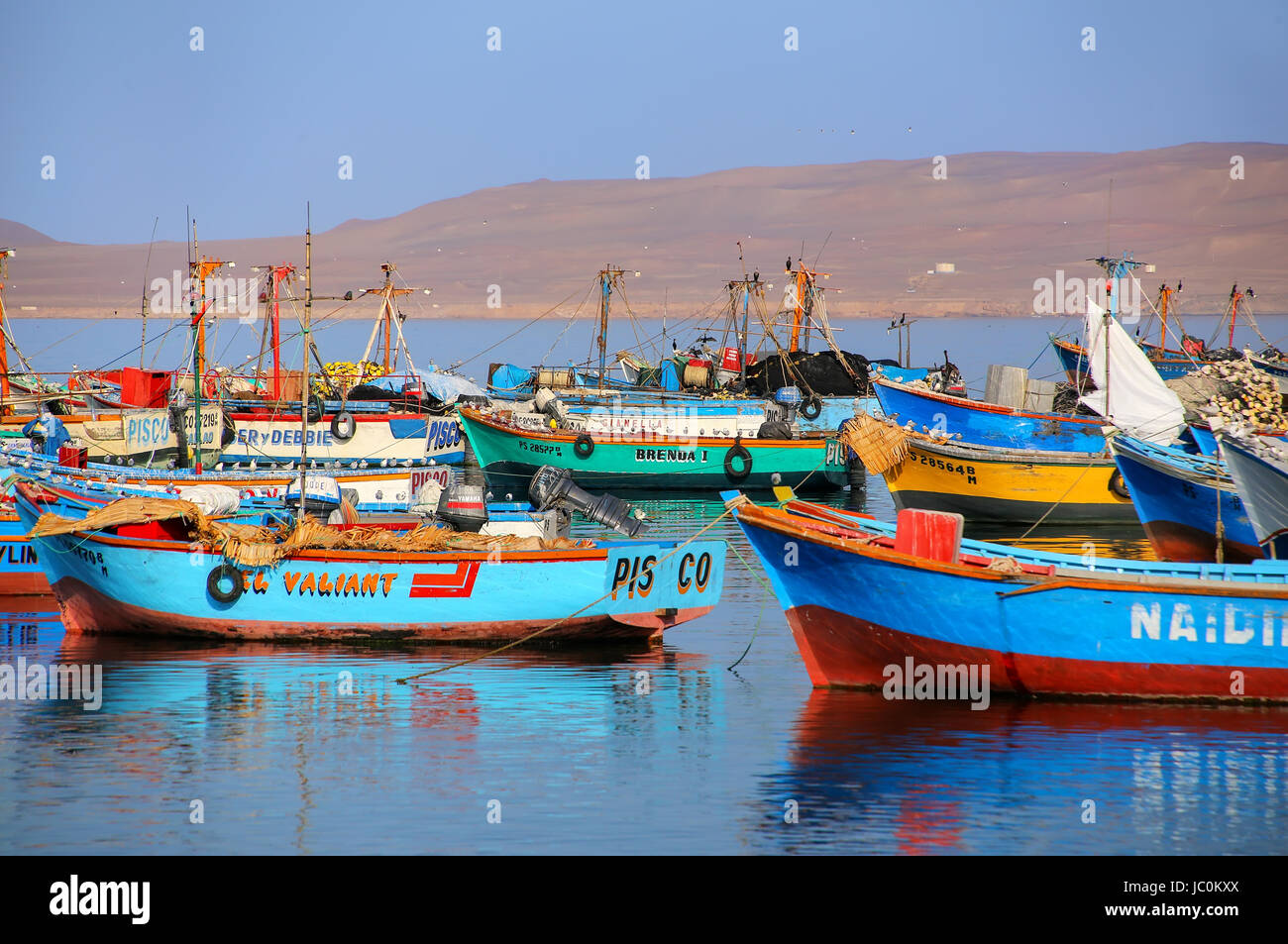 Colorful fishing boats anchored in Paracas Bay, Peru. Paracas is a ...