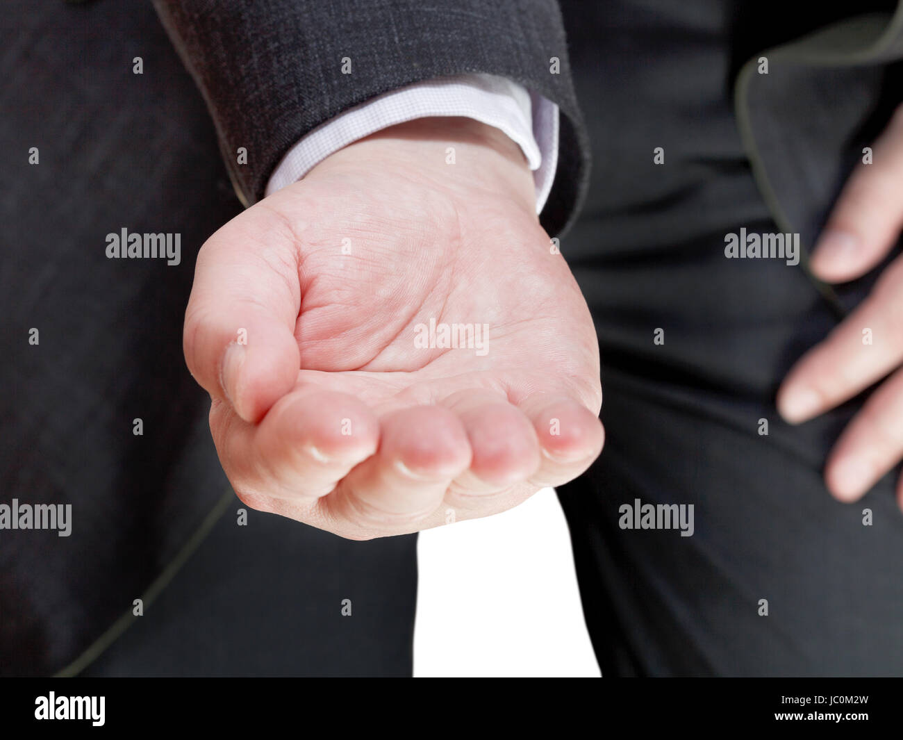 businessman holds handful - hand gesture isolated on white background ...