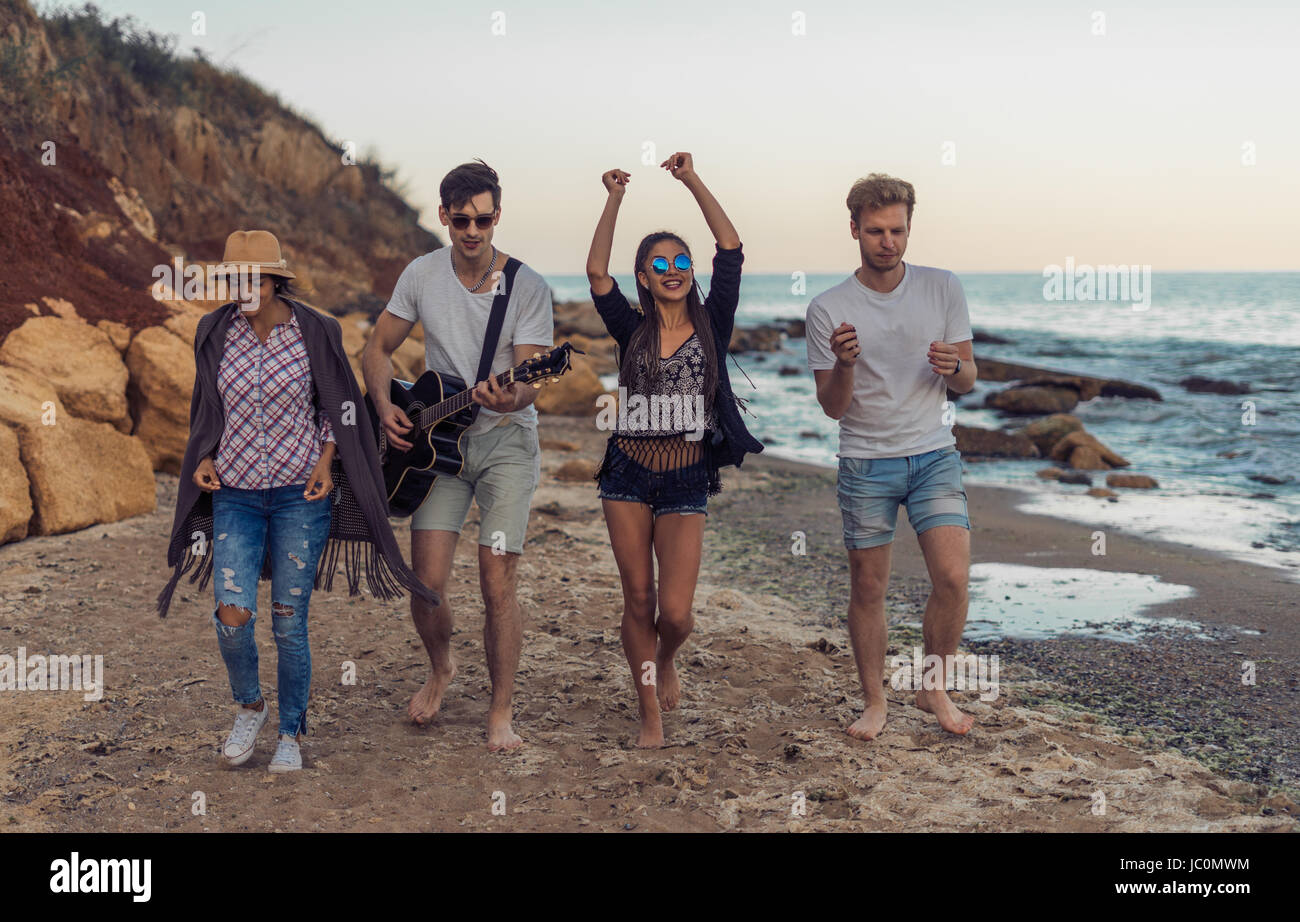 Cheerful friends walking on beach hi-res stock photography and images ...