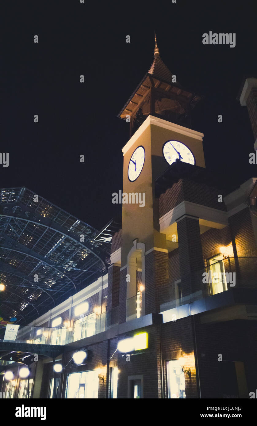 Modern clock tower at night Stock Photo - Alamy