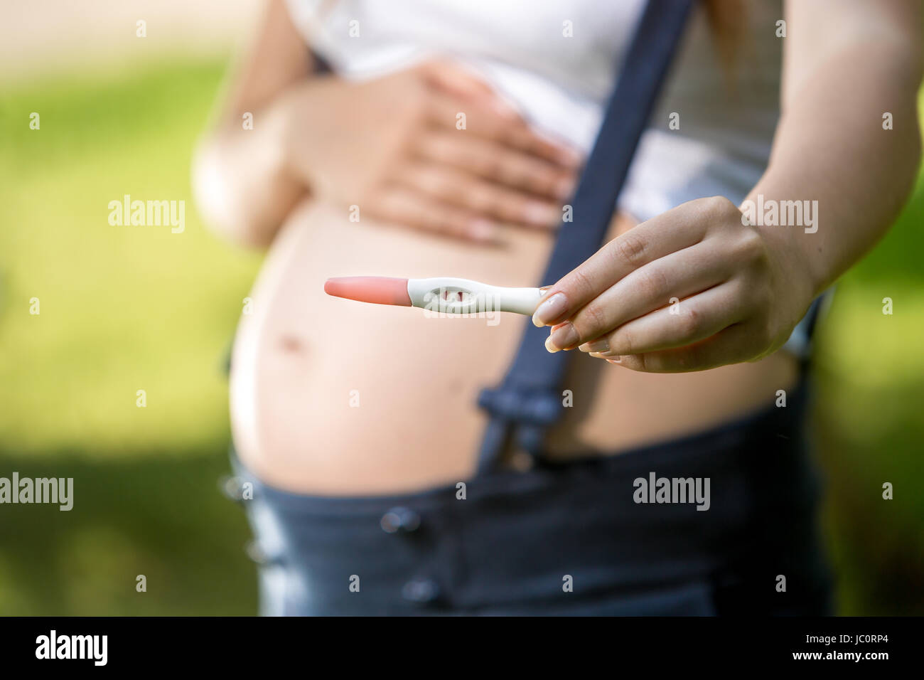 Positive pregnancy test result pregnant belly woman holding hi-res ...