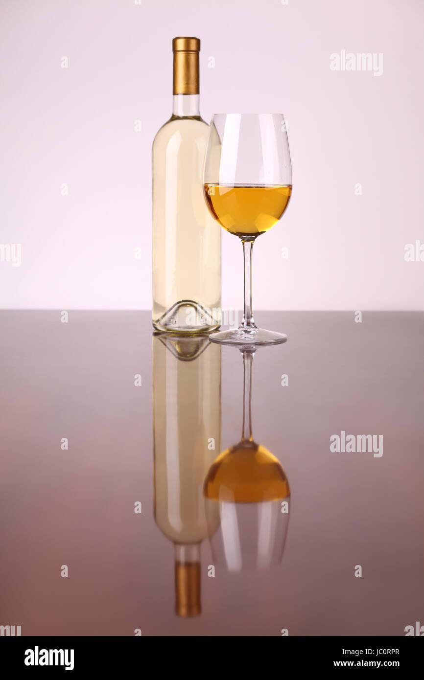 Glass and bottle of white wine over a white background Stock Photo - Alamy