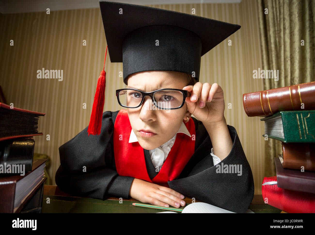 Closeup funny portrait of smart girl in graduation cap and eyeglasses ...