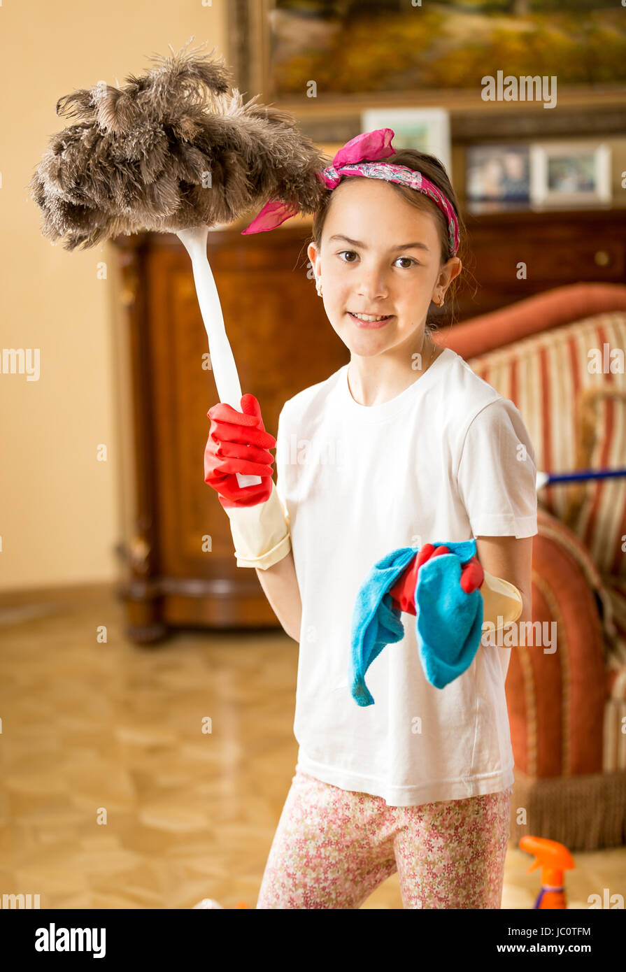 Portrait of smiling girl helping with housework and cleaning Stock ...