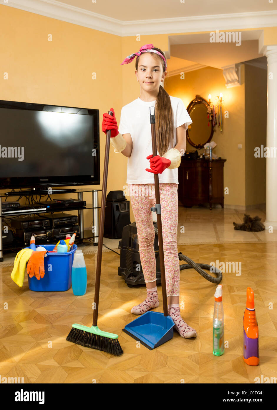 Cute teenage girl cleaning wooden floor with brush and scoop Stock ...