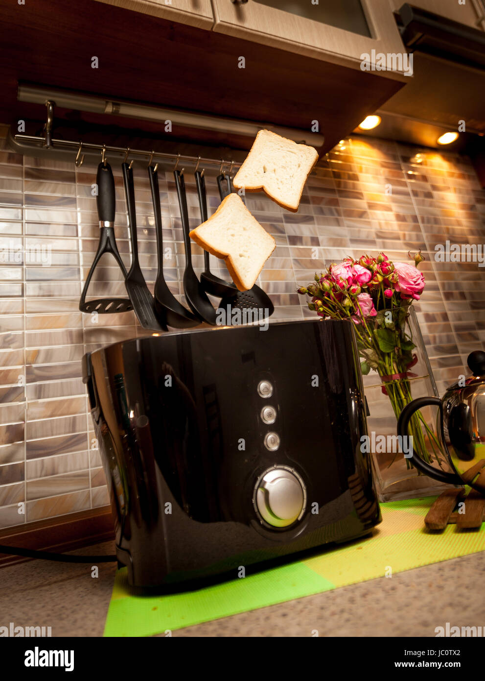 Two fresh baked toasts of white bread popping out of toaster Stock ...
