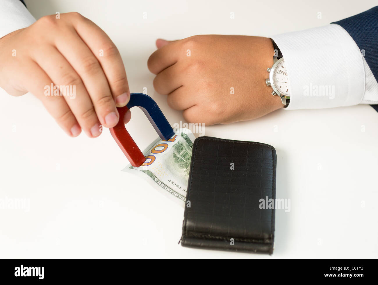 Magnet pulling money hi-res stock photography and images - Alamy