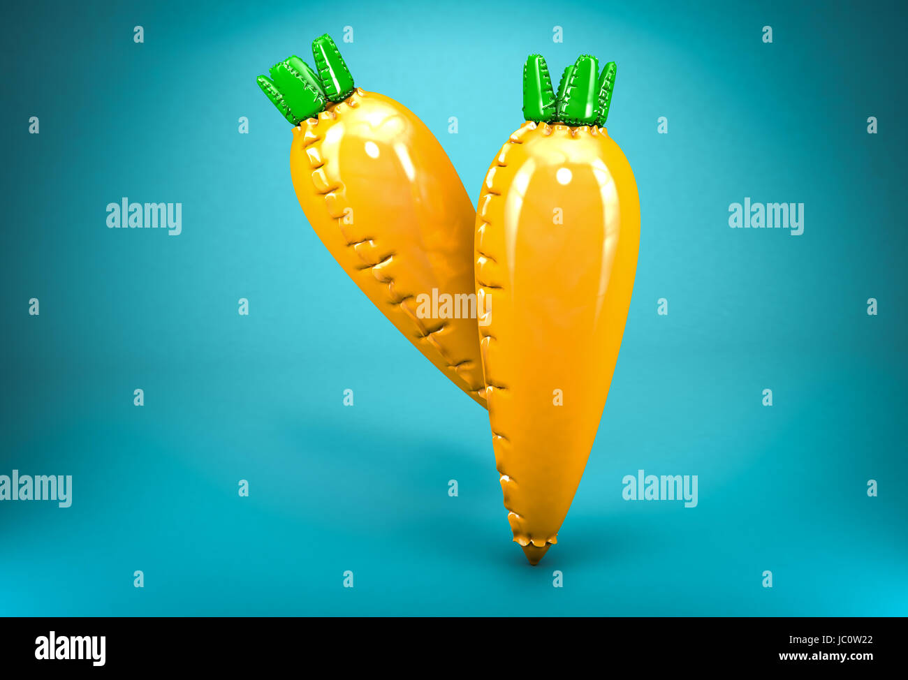 Two inflatable carrots on blue background. Concept of artificially ...