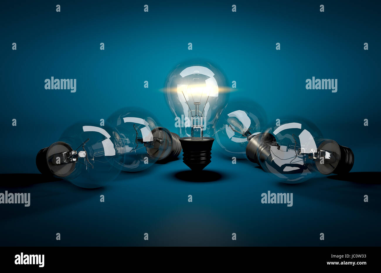 Concept of leadership. One glowing light bulb among dark ones lying on ...