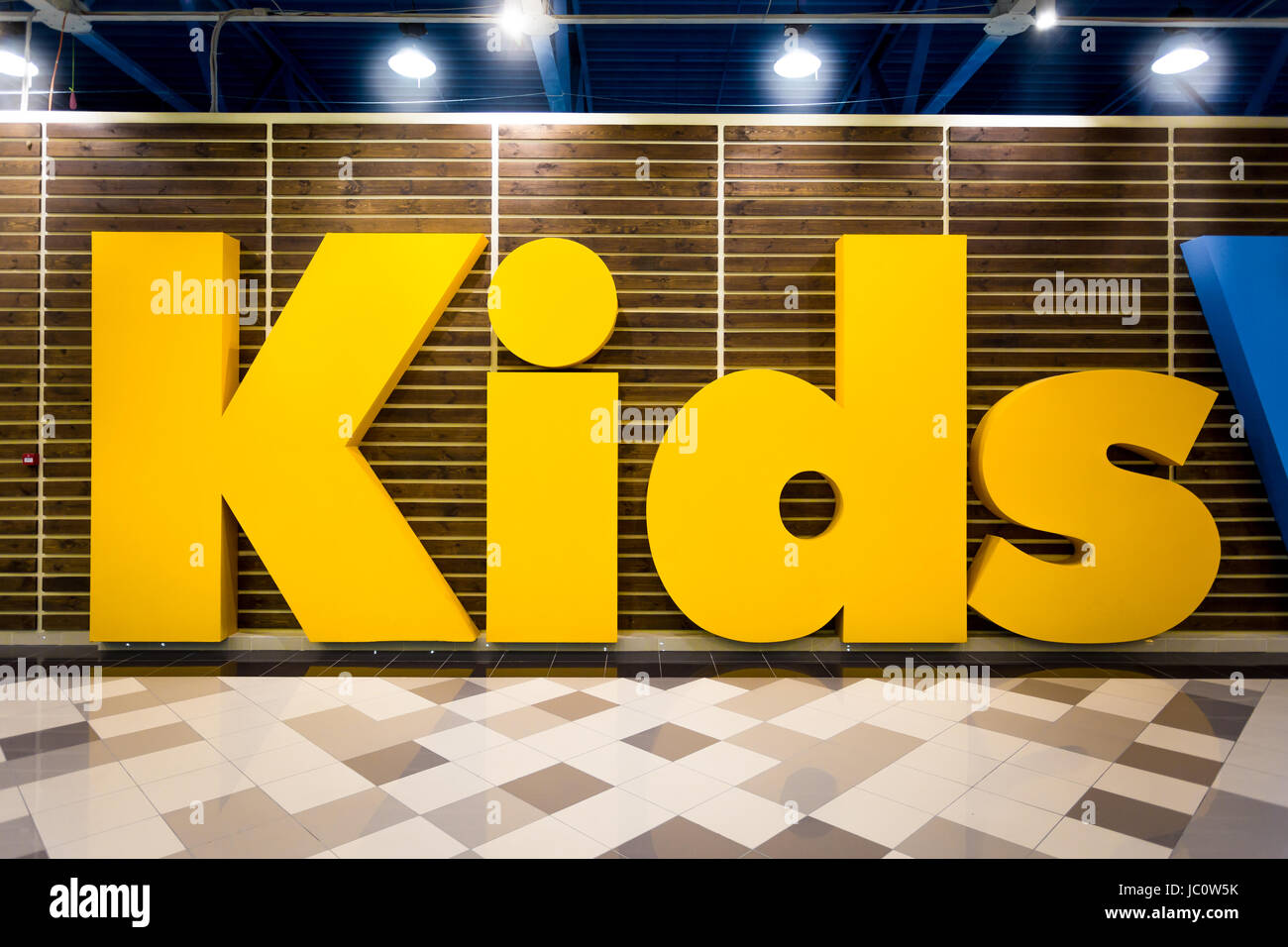 Big yellow wooden word "Kids". Childhood concept Stock Photo - Alamy