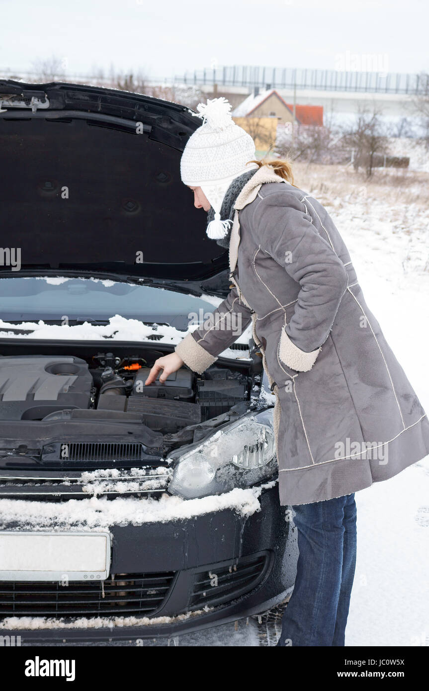Car break - woman looks into the engine compartment Stock Photo - Alamy