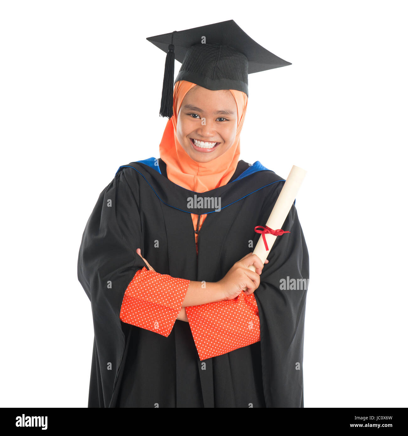 Portrait of smiling Asian female Muslim student in graduate gown ...